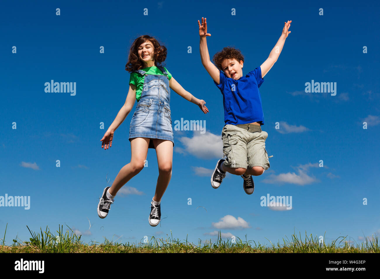 Girl and boy running, jumping outdoor Stock Photo - Alamy