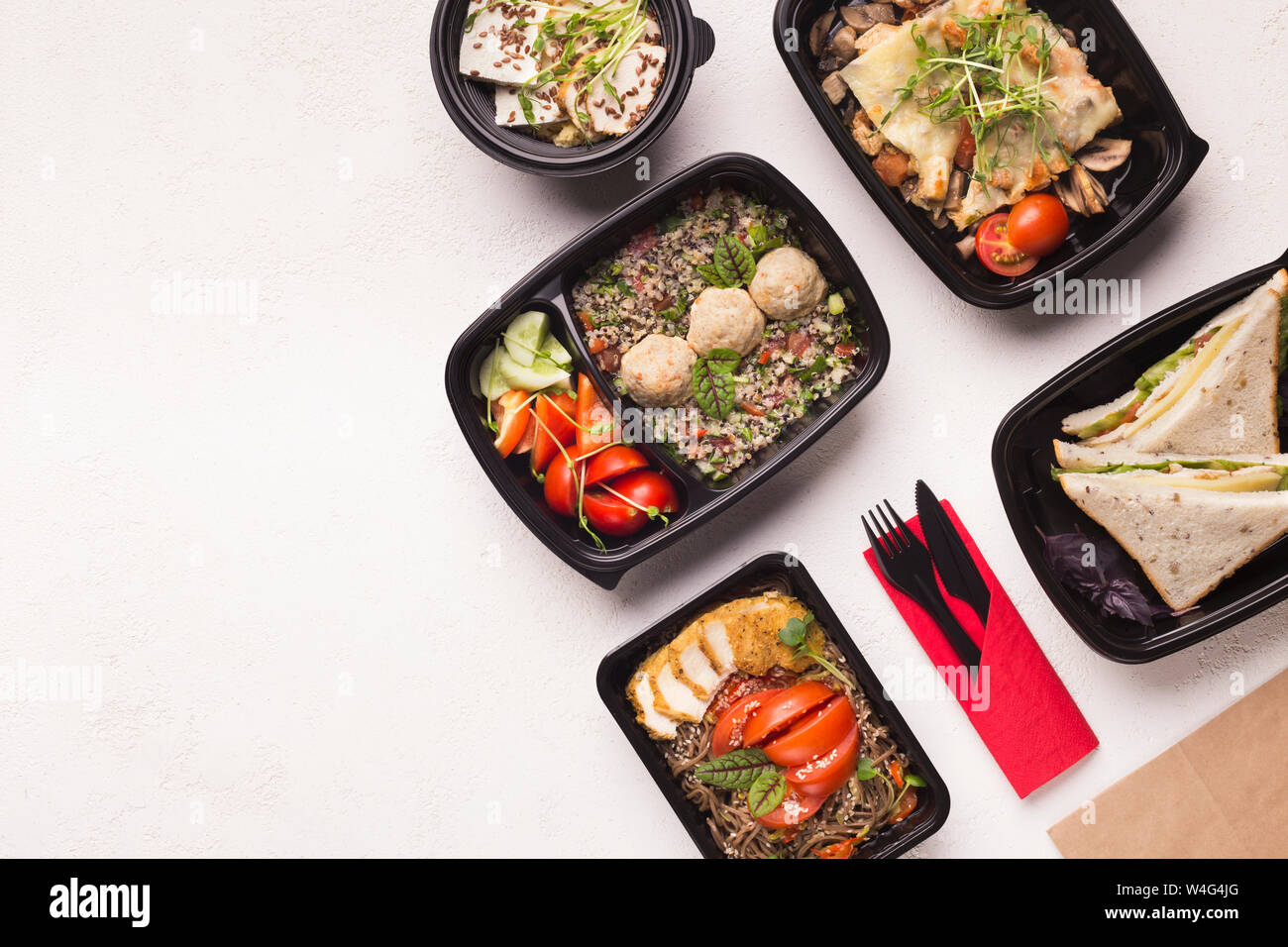 Take away healthy food in black boxes for diet nutrition on white Stock ...