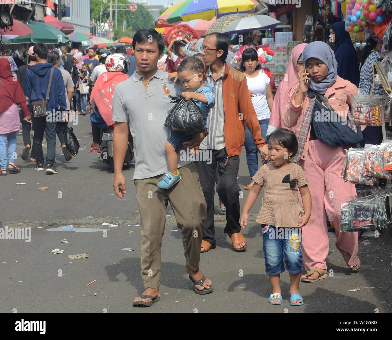 Asemka Market, Jakarta, Indonesia - June 2019 : A family walk together ...