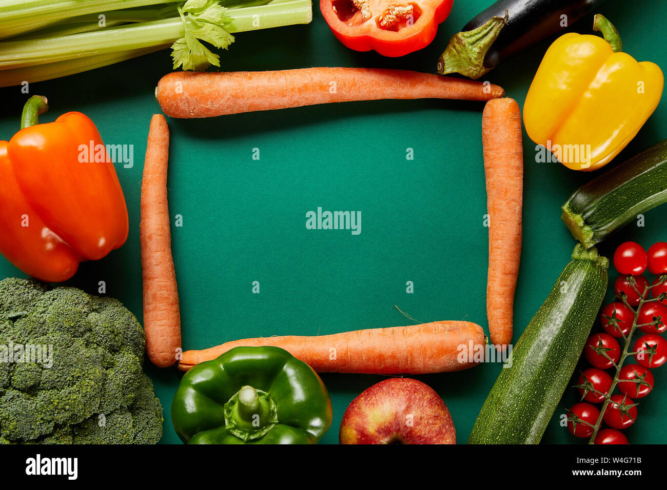 frame of green fresh vegetables and carrots on green background Stock ...