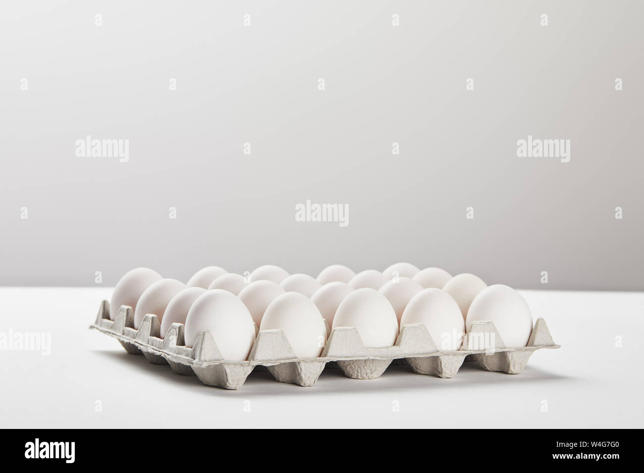 chicken eggs in carton box on white surface Stock Photo - Alamy