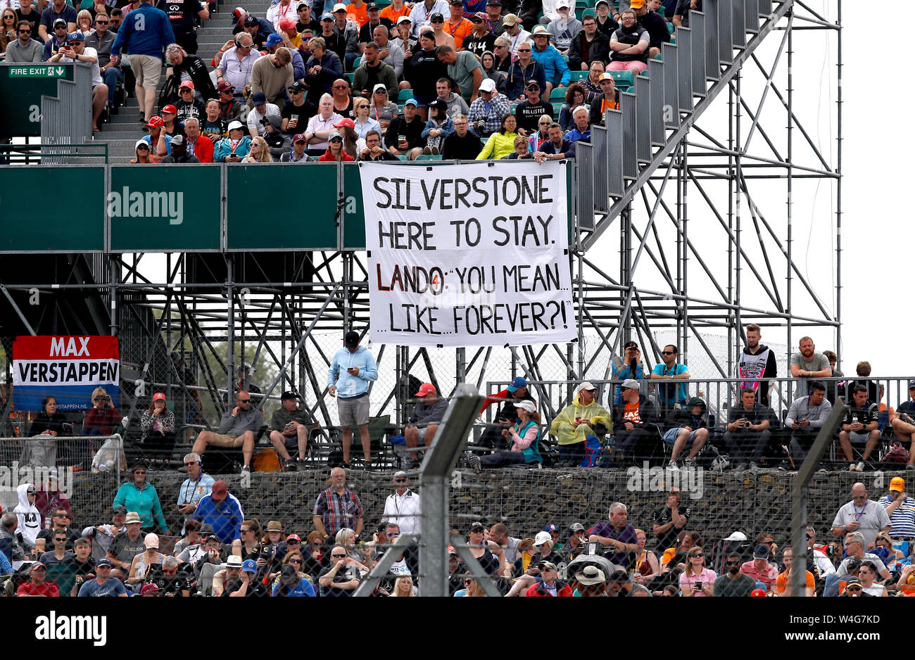 Fans in the stands hold up banners to celebrate F1 extending their ...