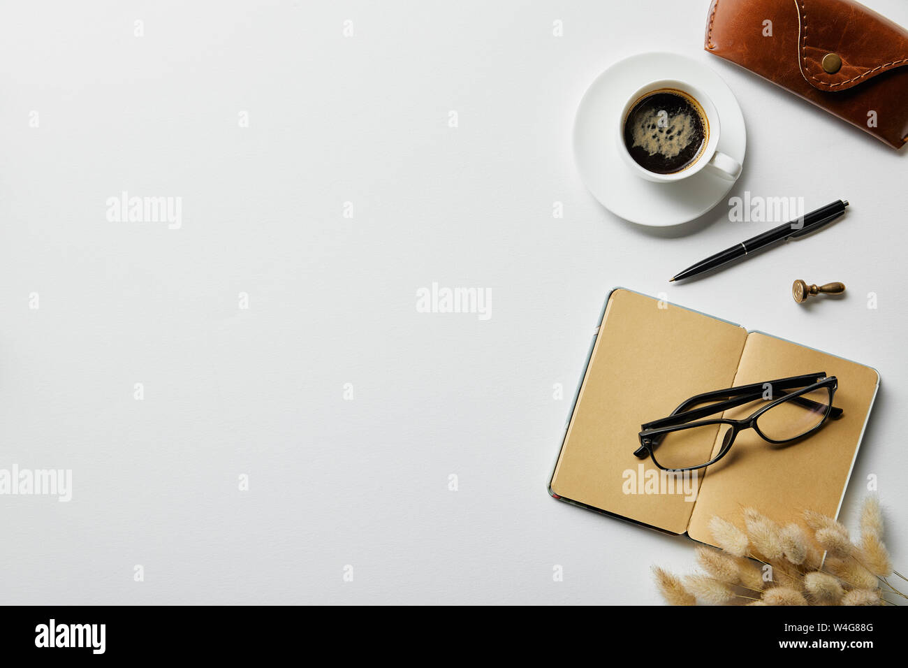 top view of coffee, notepad with pen and case on white surface Stock ...