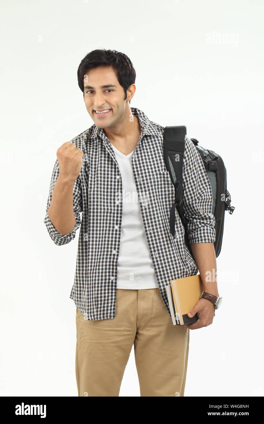 Portrait of an Indian college student smiling and punching the air ...
