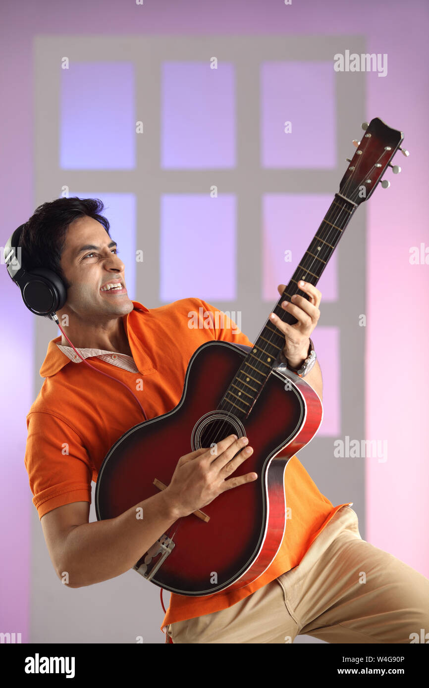 Playing guitar with teeth hi-res stock photography and images - Alamy
