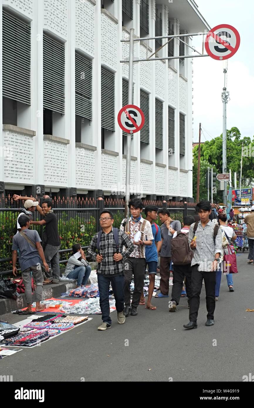 Jakarta, Indonesia - June 2019 : A group of people walk near street ...