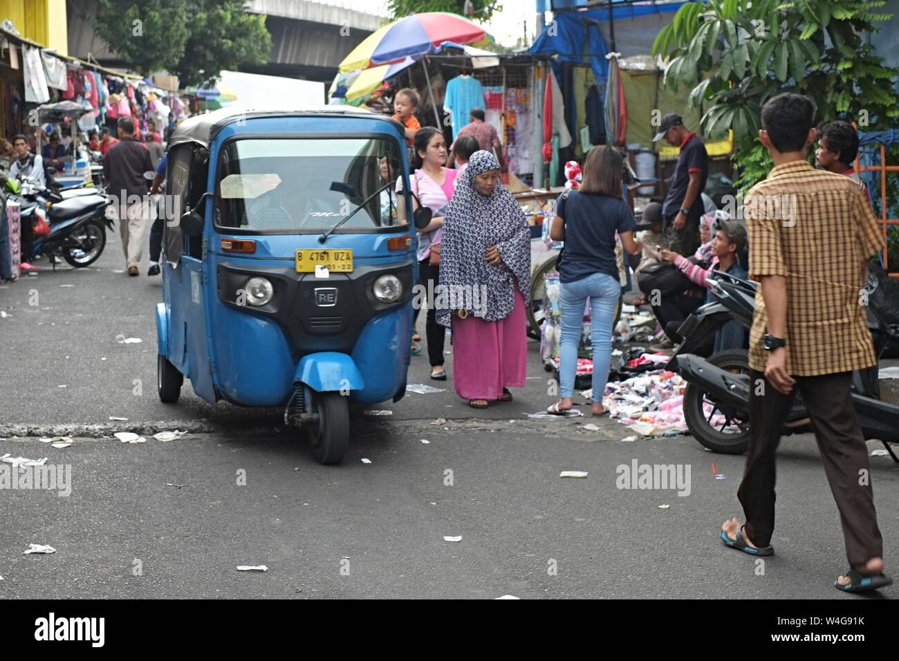 Jakarta, Indonesia - June 2019 : A view of a street with blue bajaj ...