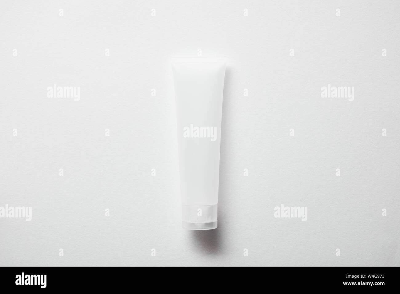 top view of empty plastic cream tube on white Stock Photo - Alamy