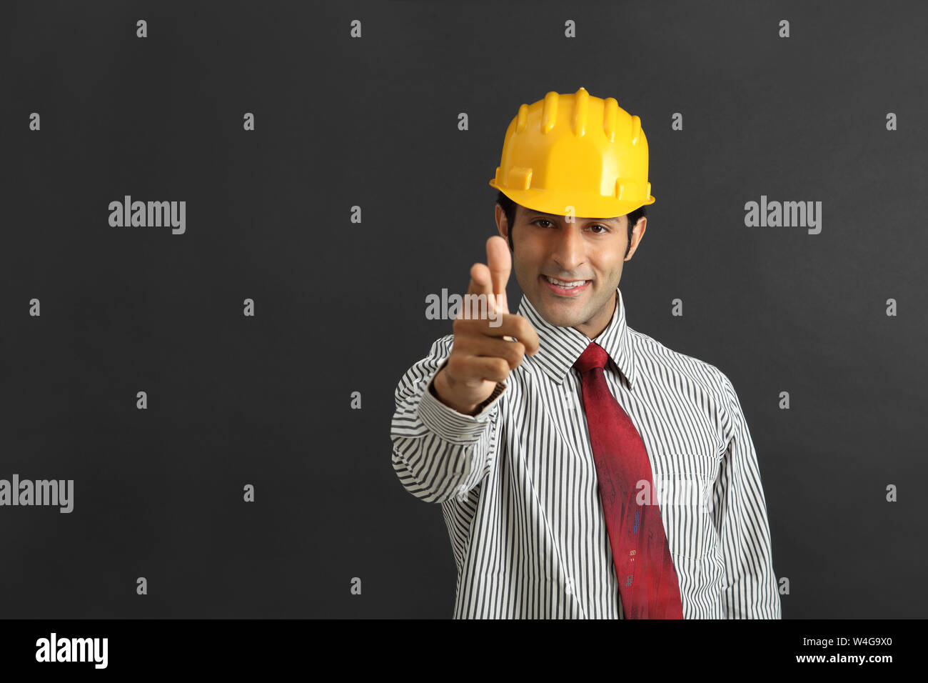 Male architect making gun sign Stock Photo - Alamy