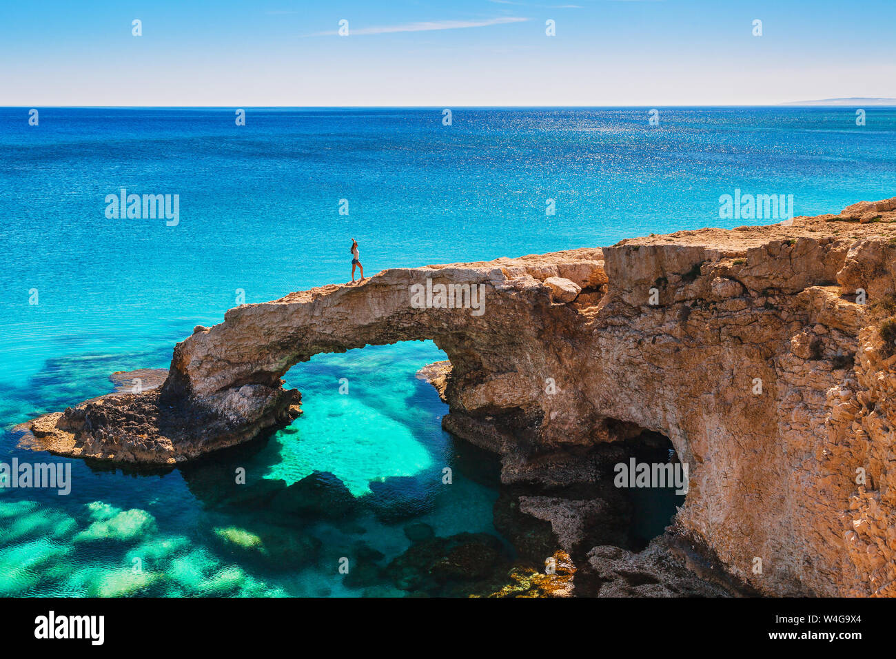 Woman on the beautiful natural rock arch near of Ayia Napa, Cavo Greco ...