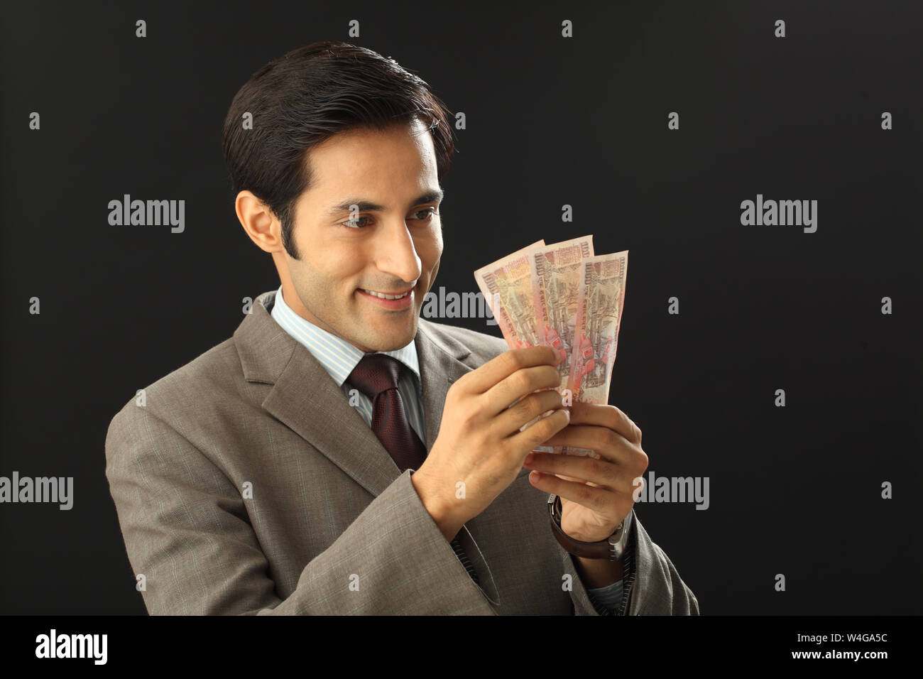 Businessman counting money Stock Photo - Alamy