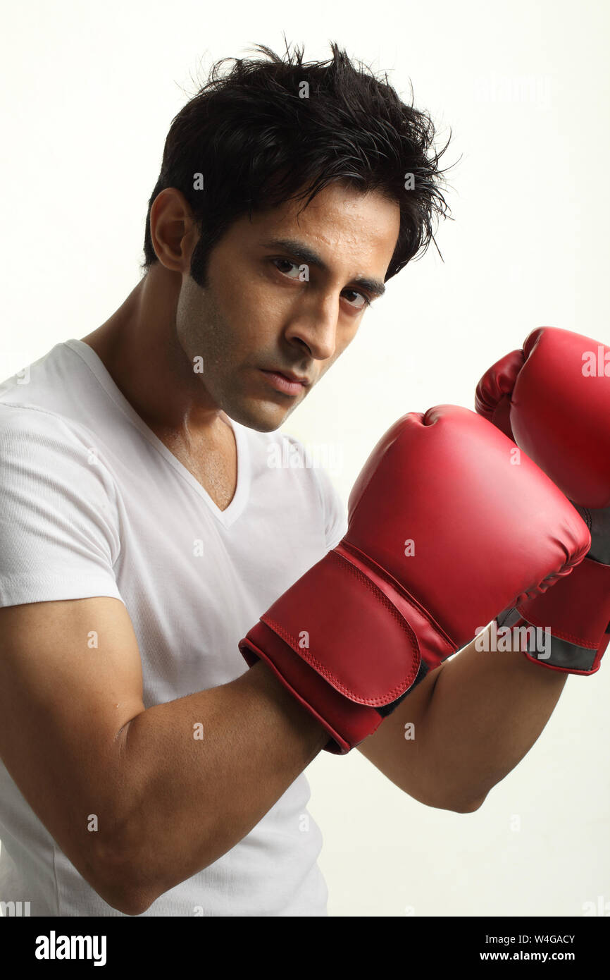 Indian young man wearing boxing gloves Stock Photo - Alamy