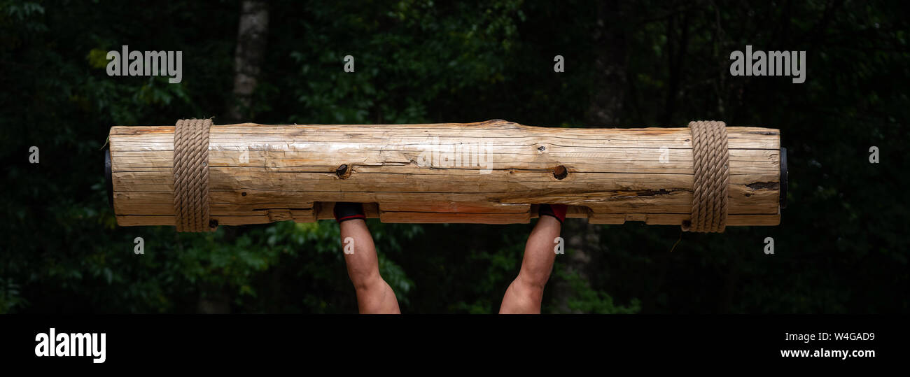 Strongest man in the world competition. Muscular hands lifting up heavy ...