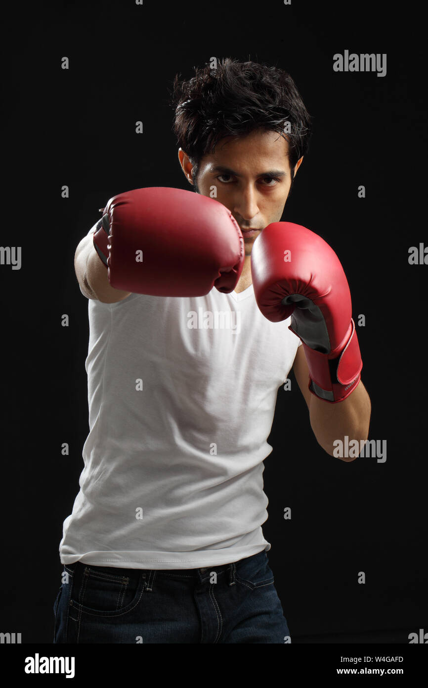 Man wearing boxing gloves Stock Photo - Alamy