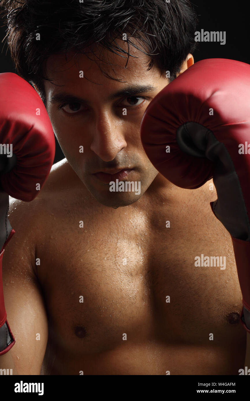 Man wearing boxing gloves Stock Photo - Alamy