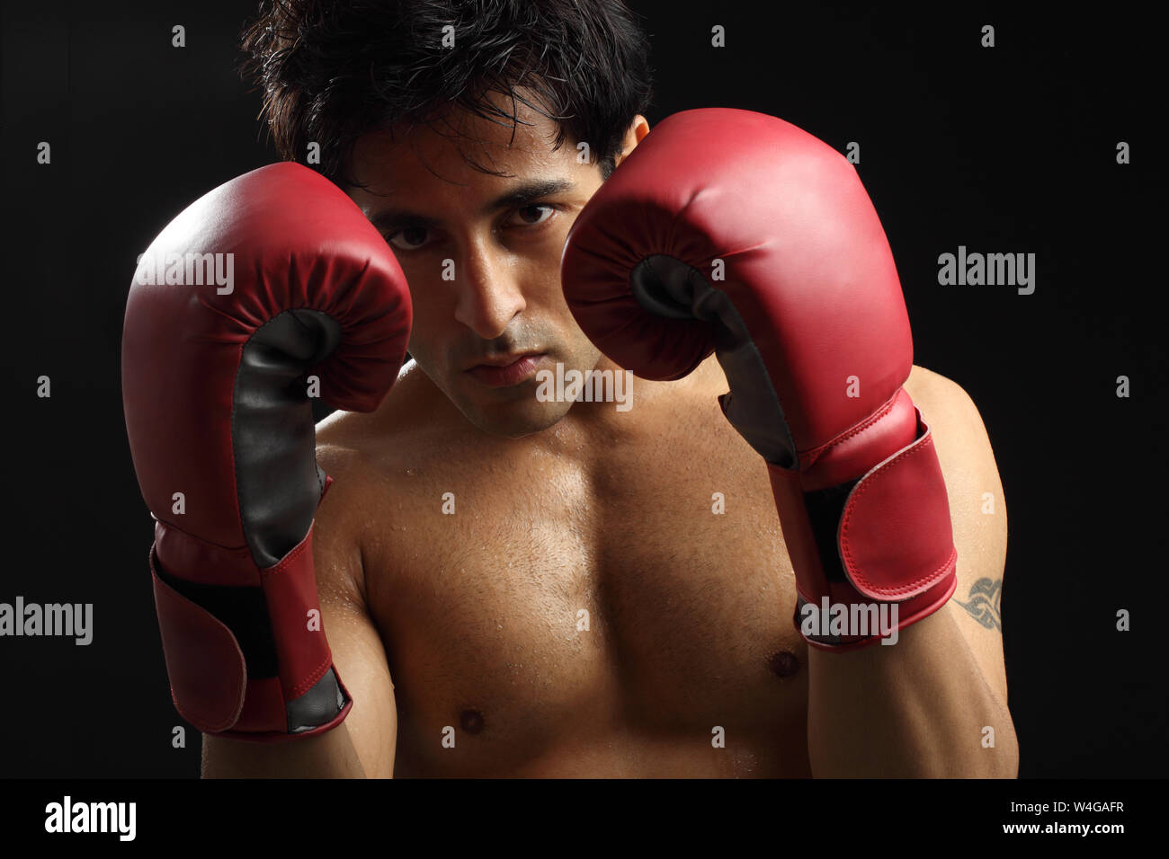 Man wearing boxing gloves Stock Photo - Alamy