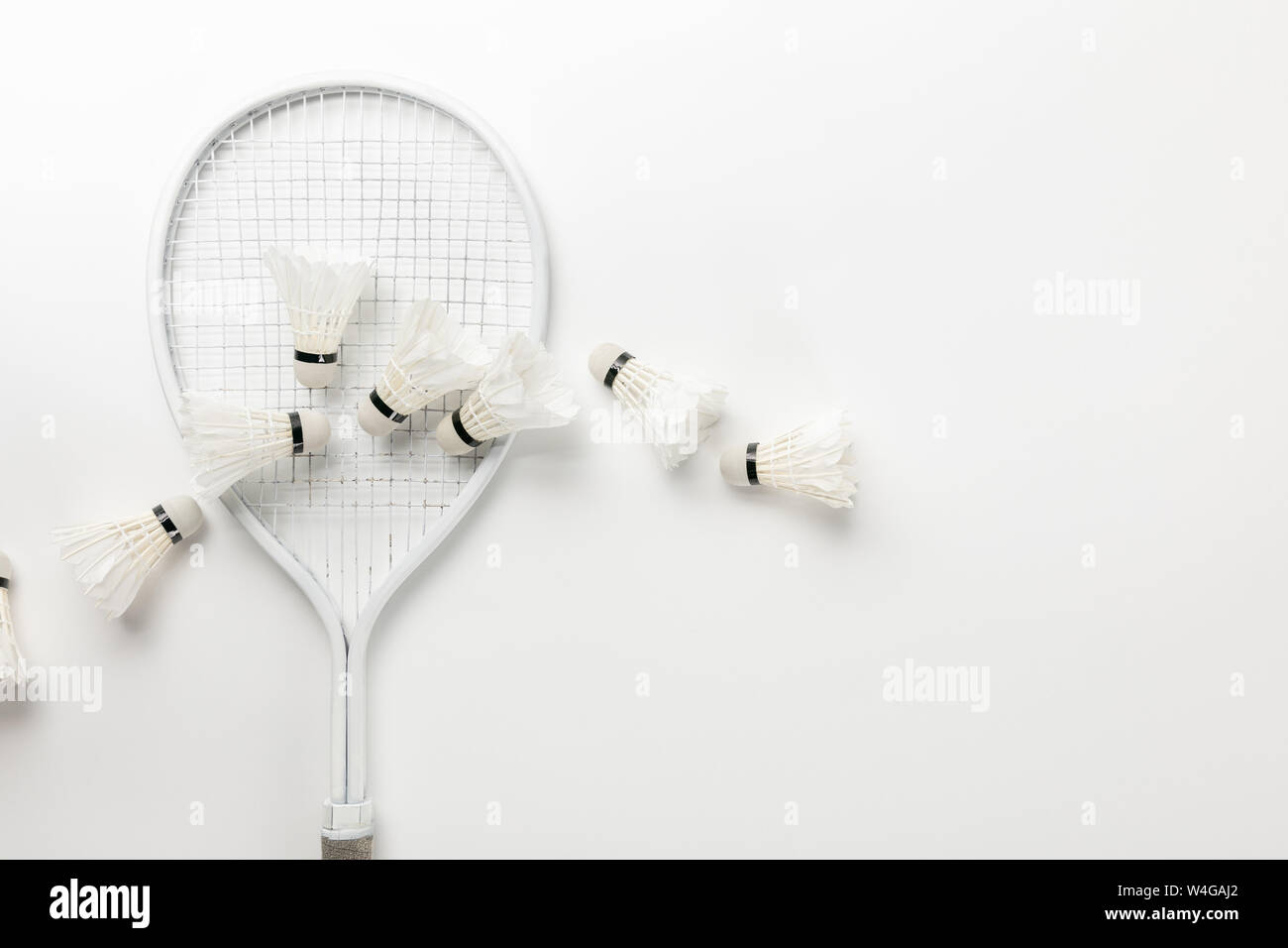 top view of white badminton racket and shuttlecocks on white background ...