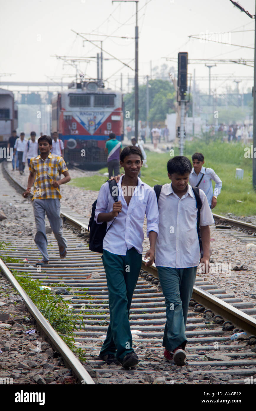 School students walking on railway tracks, Delhi, India Stock Photo - Alamy