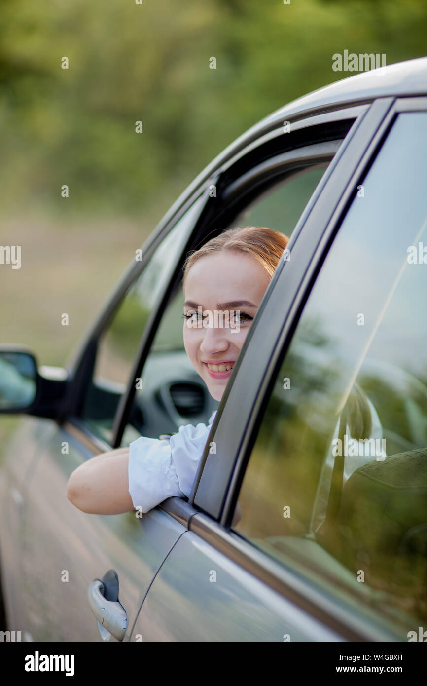 Portrait shot through windshield of pretty woman in car Stock Photo - Alamy