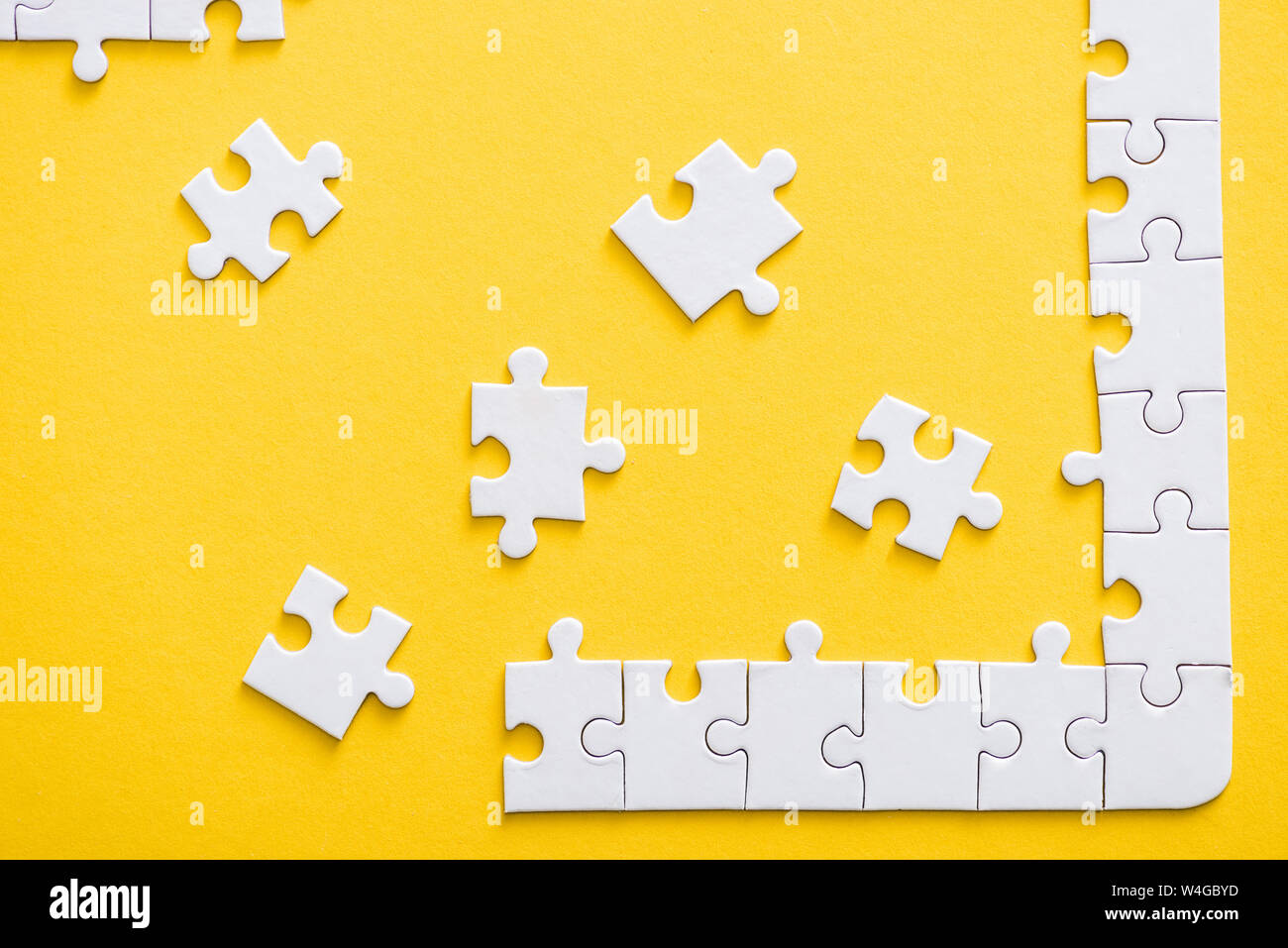 top view of incomplete connected puzzle pieces near finished line ...