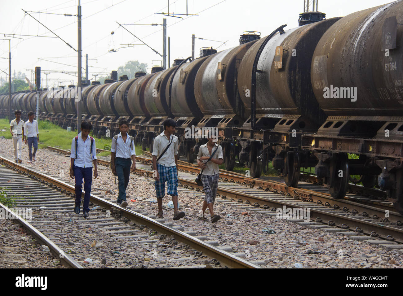 School students walking on railway tracks, Delhi, India Stock Photo - Alamy
