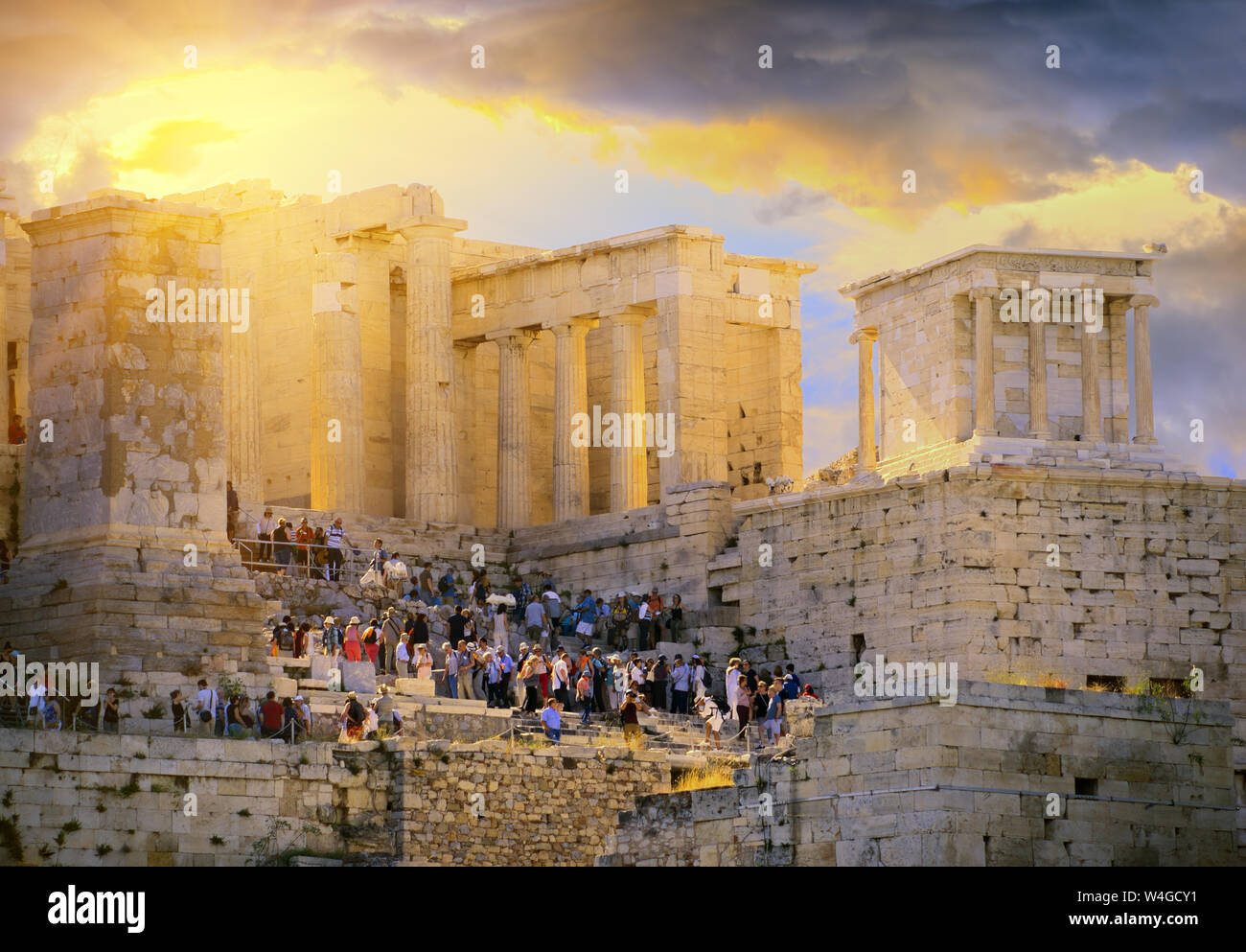 Dramatic sunrise over the antique Acropolis of Athens. Tourists wander about the Athenian ...