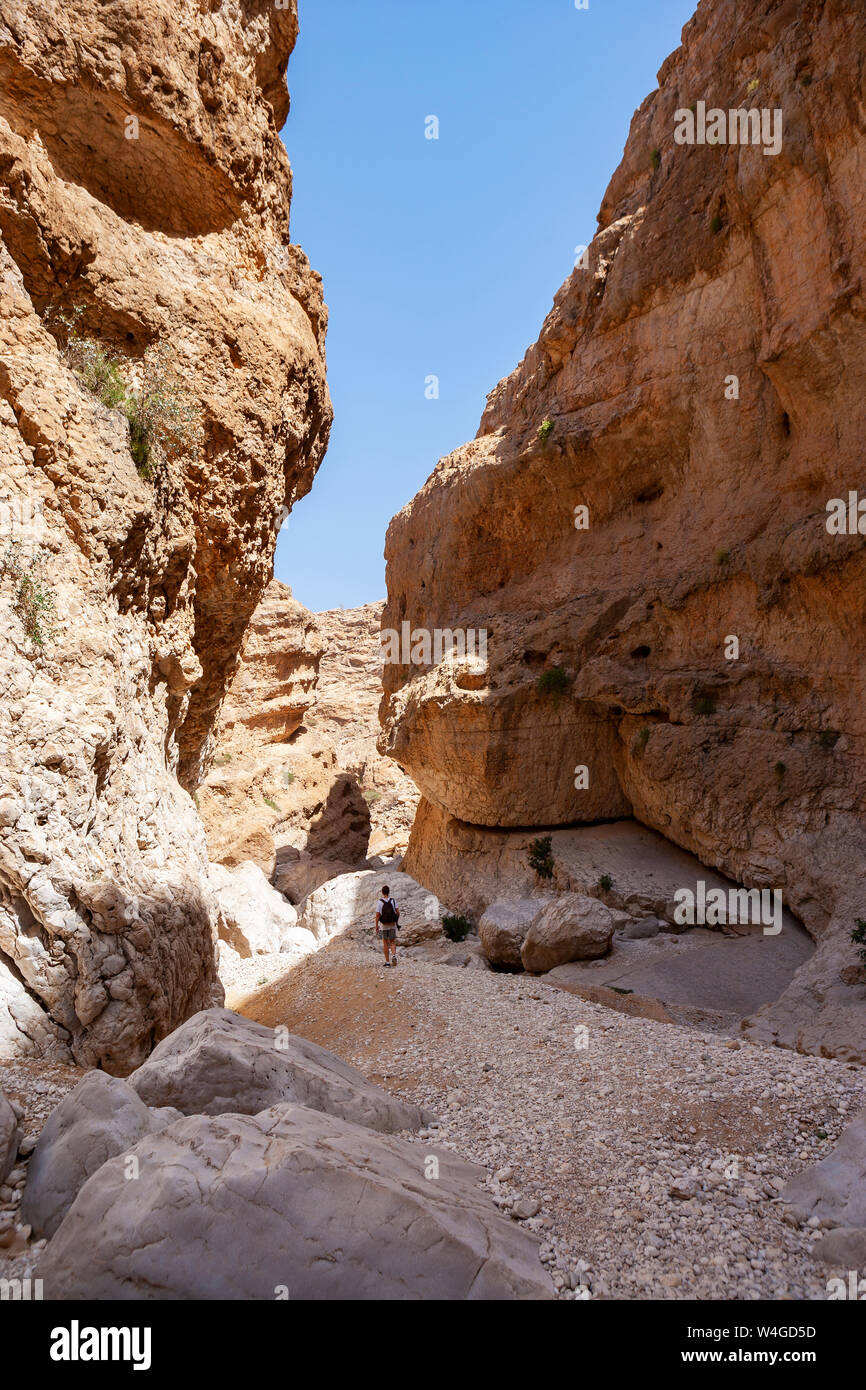 Man walking through rocks, Wadi Bani Khalid, Oman Stock Photo - Alamy