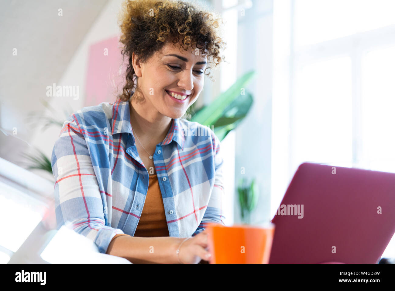 Smiling office worker using modern hi-res stock photography and images ...