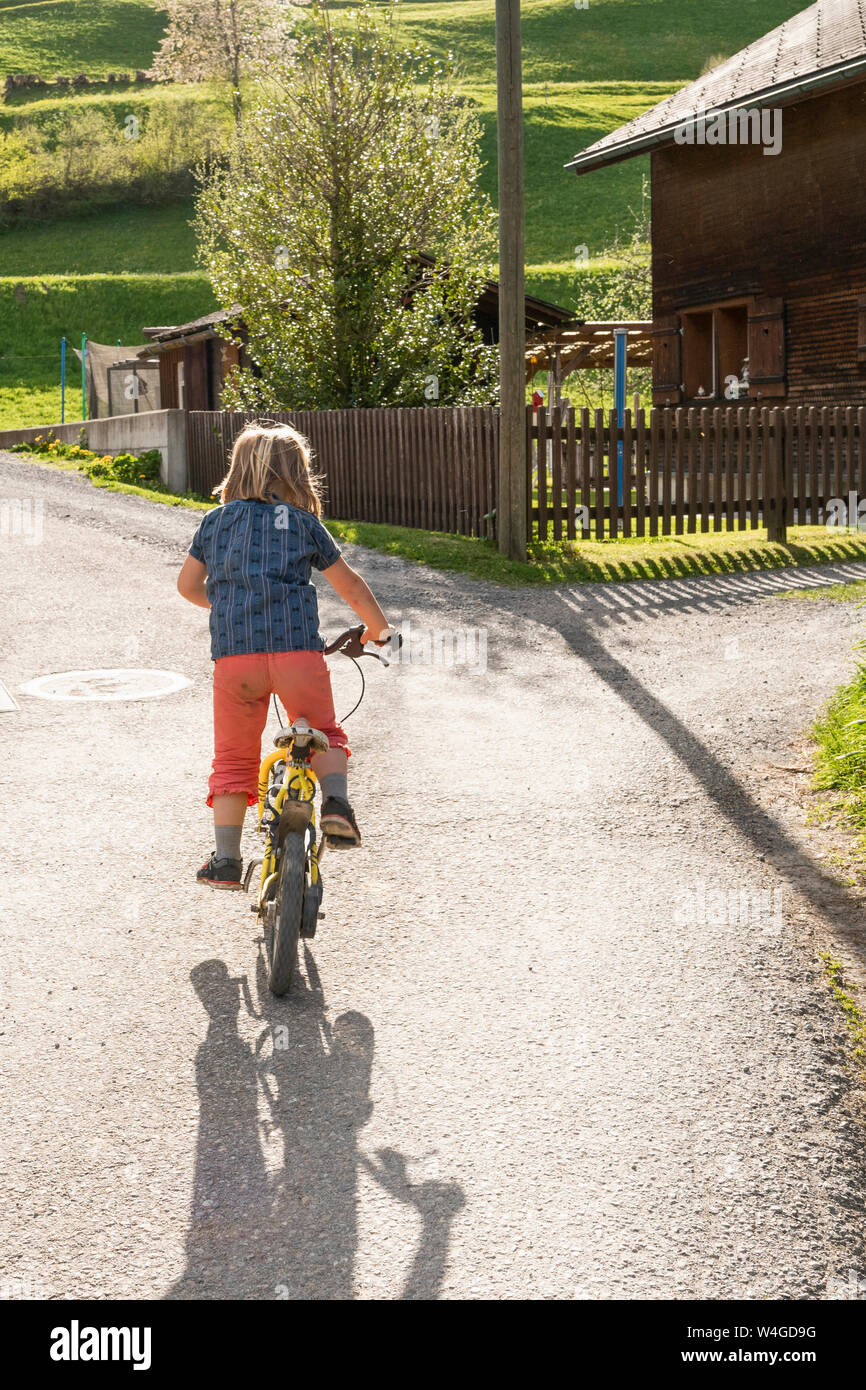 Girl riding bicycle on rural path Stock Photo - Alamy