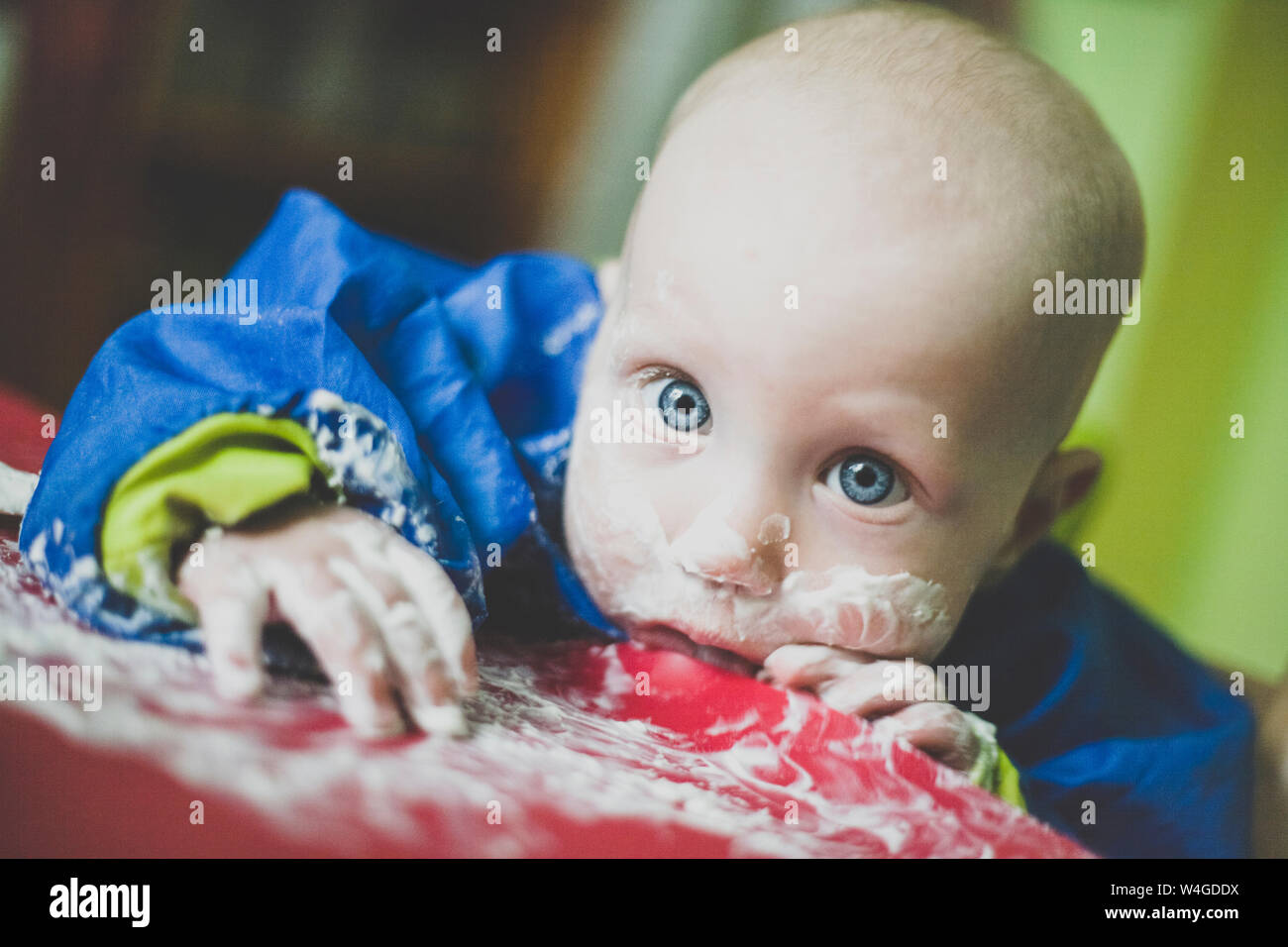 Portrait of baby boy making mess while eating Stock Photo - Alamy