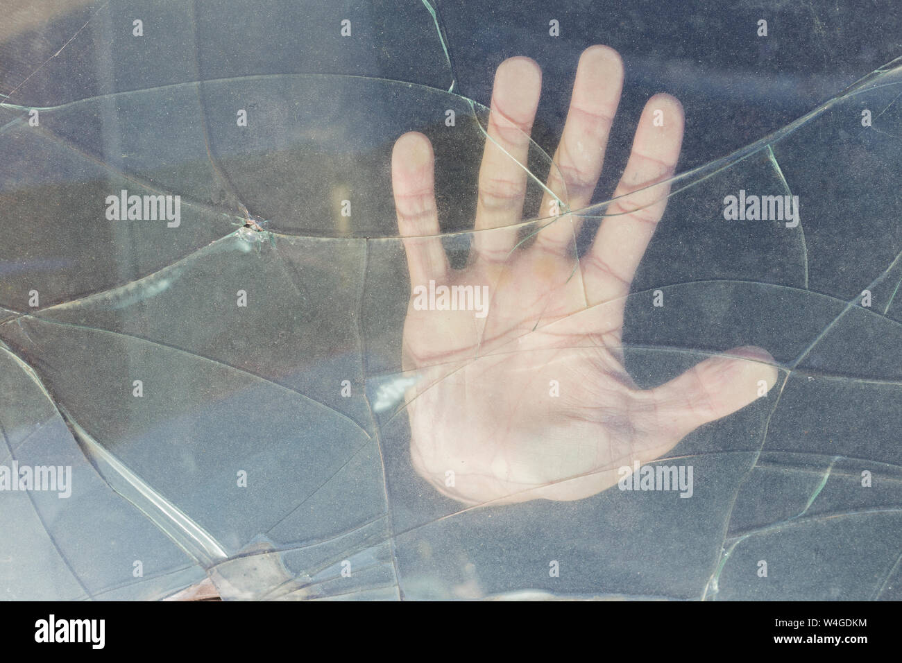 Hand of a young man behind broken windscreen on a scrapyard Stock Photo ...