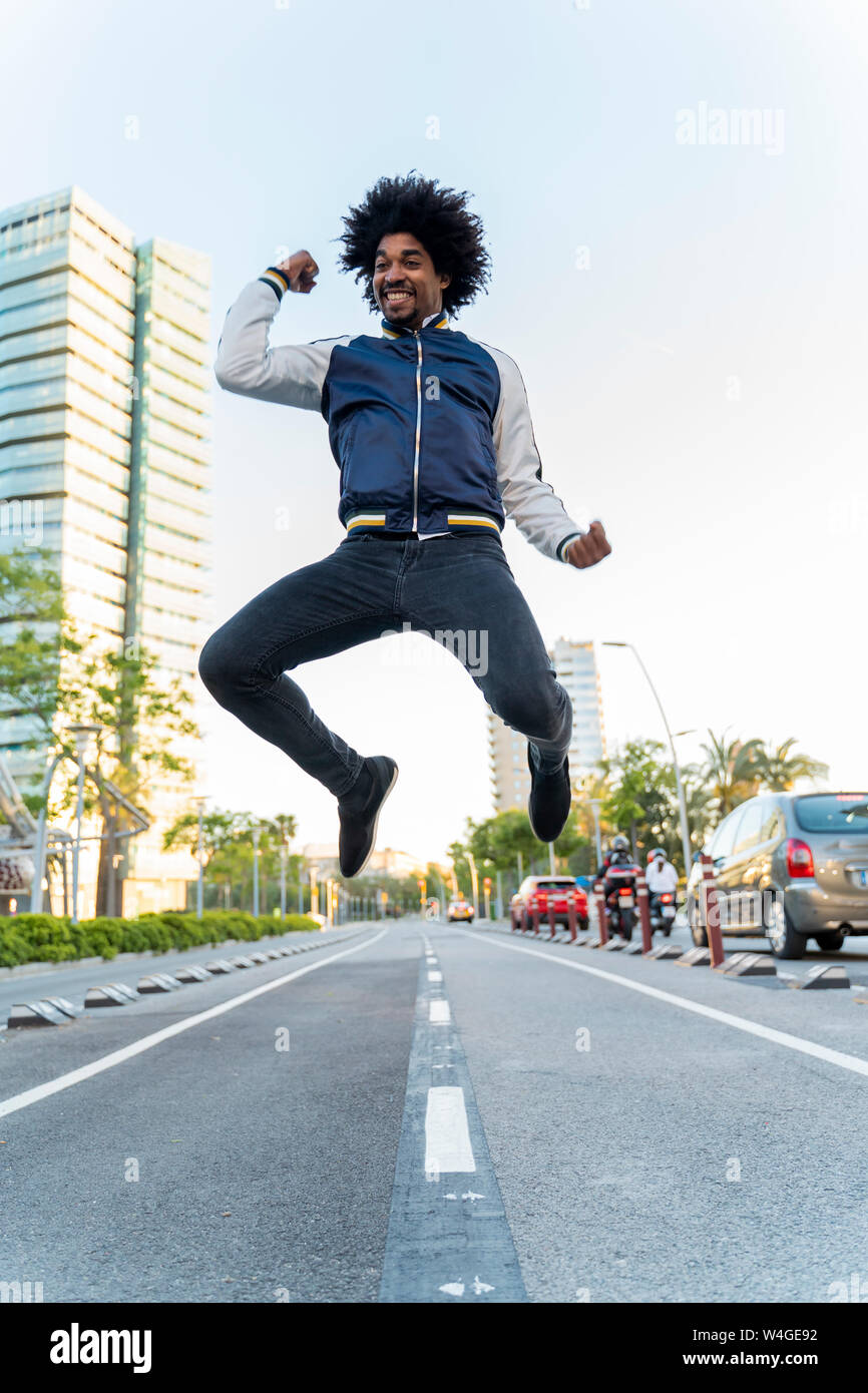 One african man jumping happy hi-res stock photography and images - Alamy