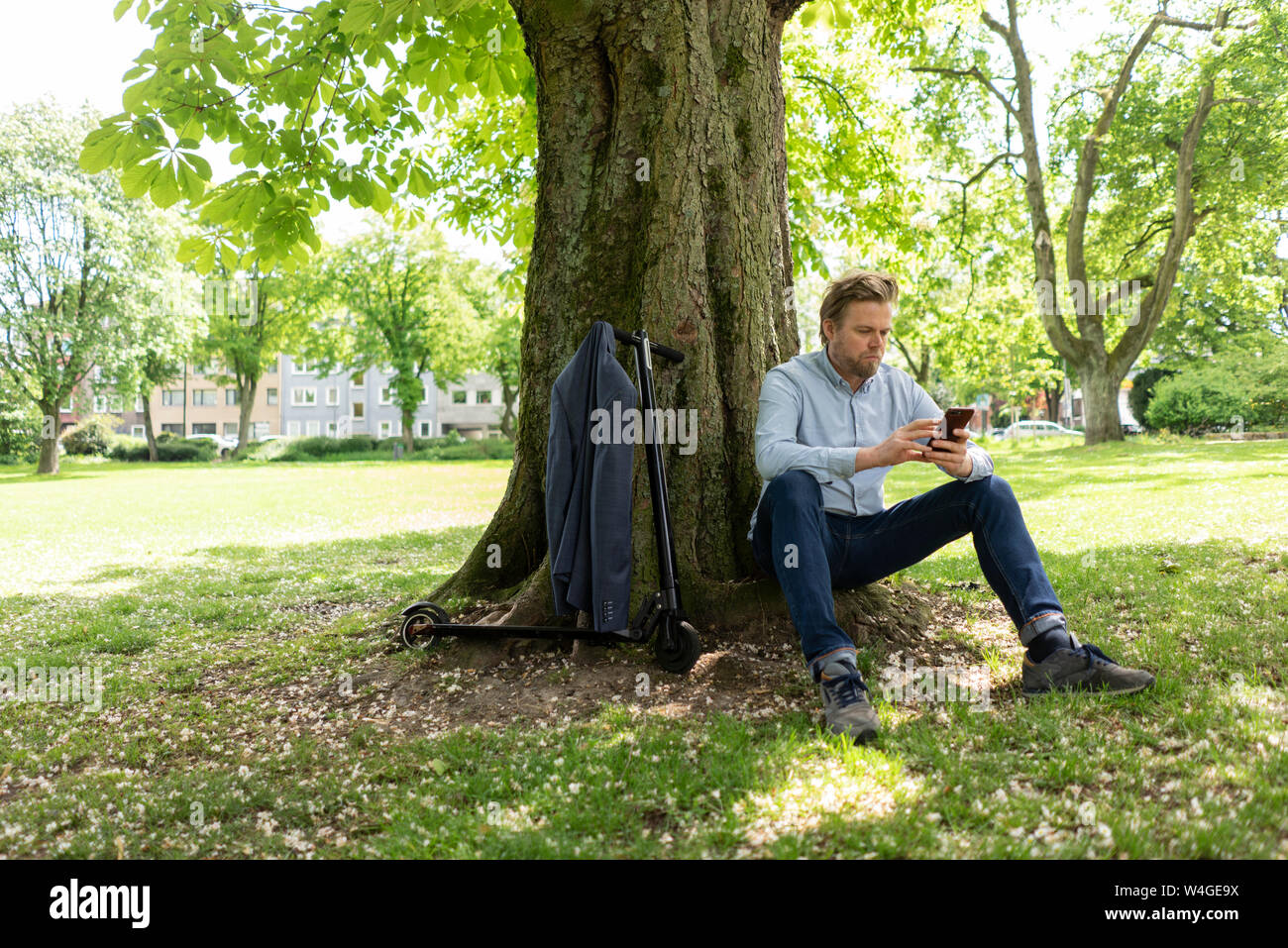 Business man sitting beneath tree hi-res stock photography and images ...