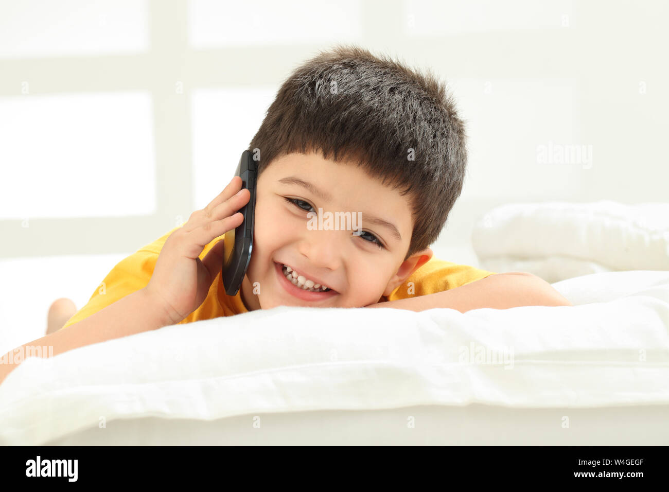 Indian boy talking on a mobile phone Stock Photo - Alamy