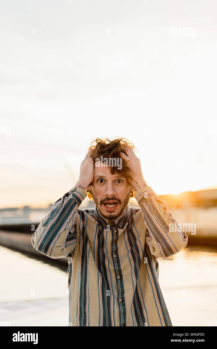 Portrait of staring man with hands on his hand at sunset Stock Photo ...