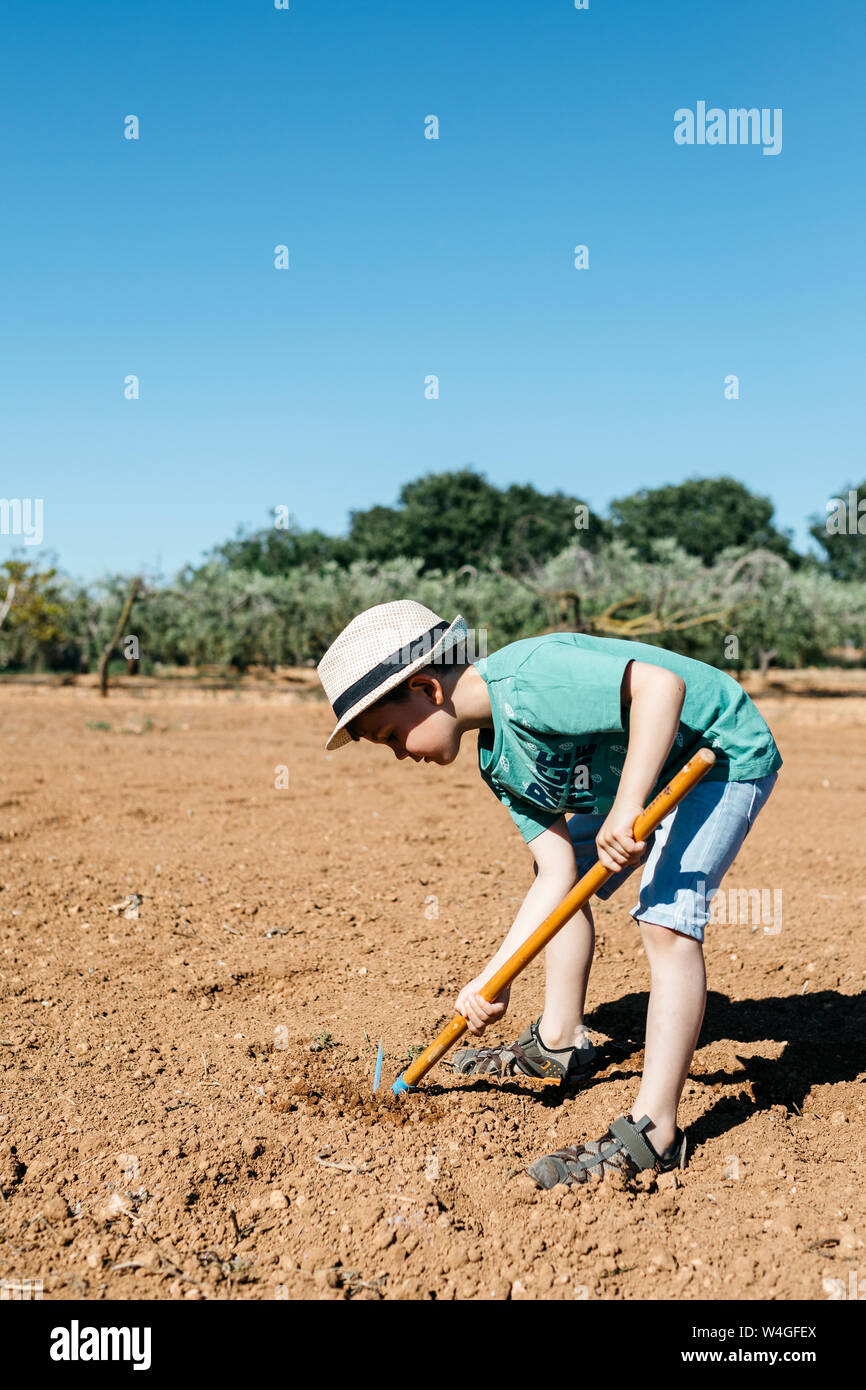 Child plowing soil hi-res stock photography and images - Alamy