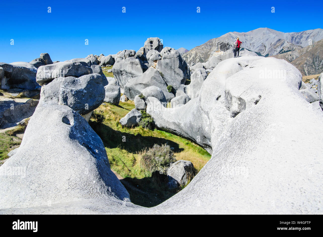 Woman standing on the Limestone outcrops of Castle Hill, South Island ...