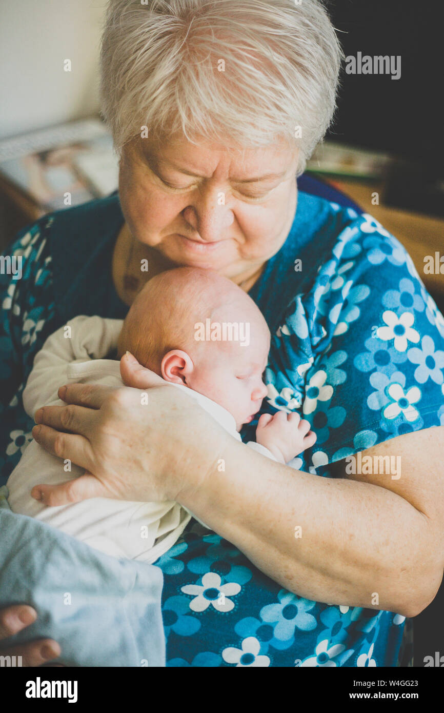 Grandmother holding her sleeping baby granddaughter Stock Photo - Alamy
