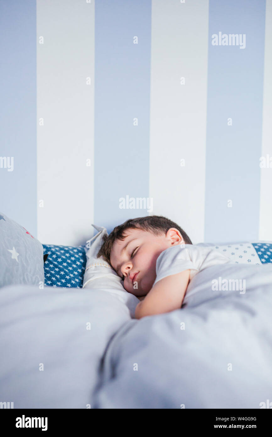 Little boy sleeping on bed in the morning Stock Photo - Alamy