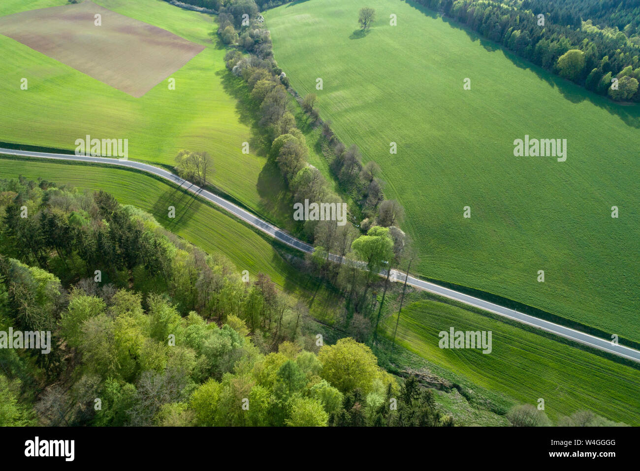 Aerial view of rural road through landscape with agricultural fields ...
