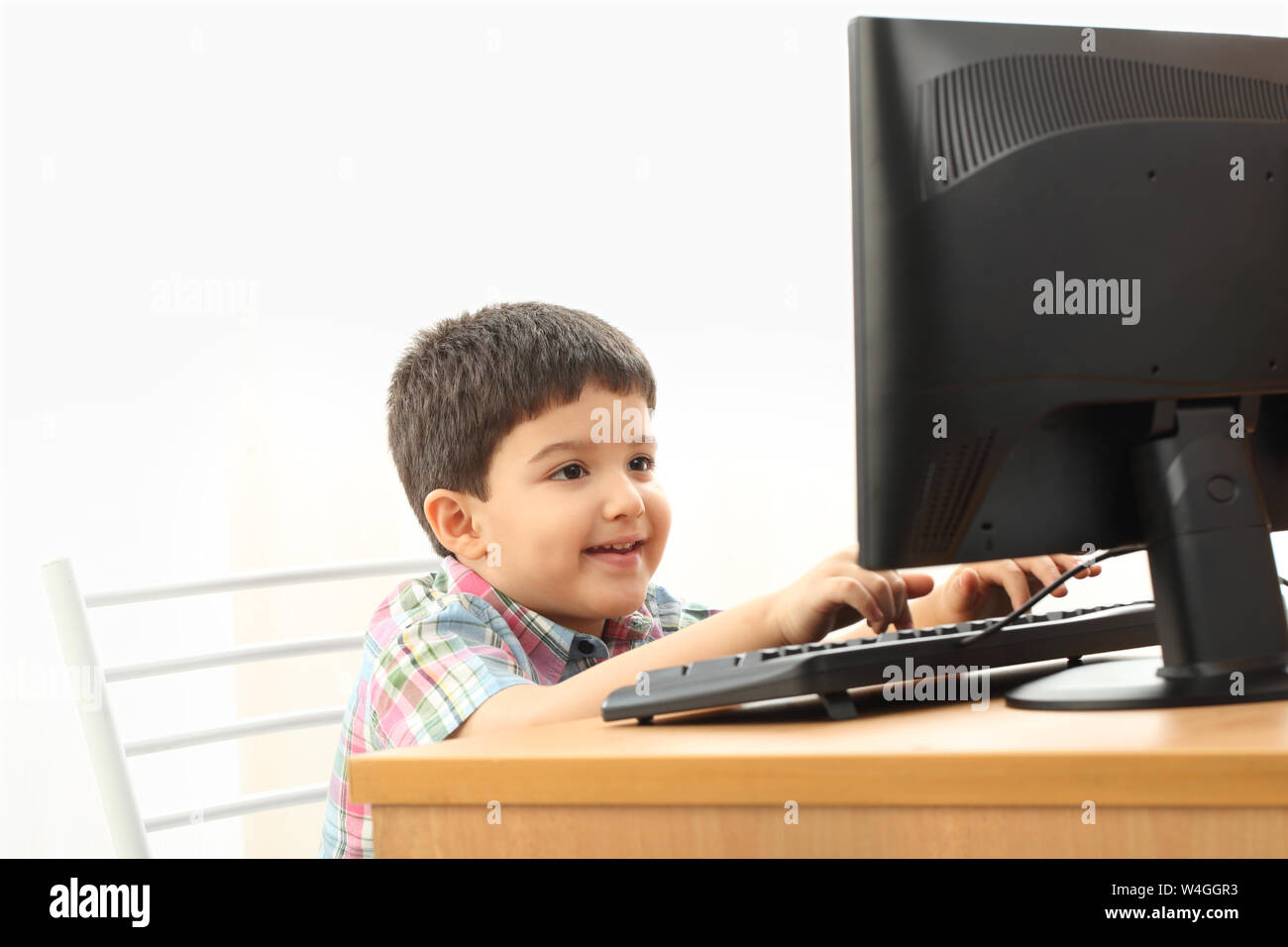 Boy working on a computer Stock Photo - Alamy