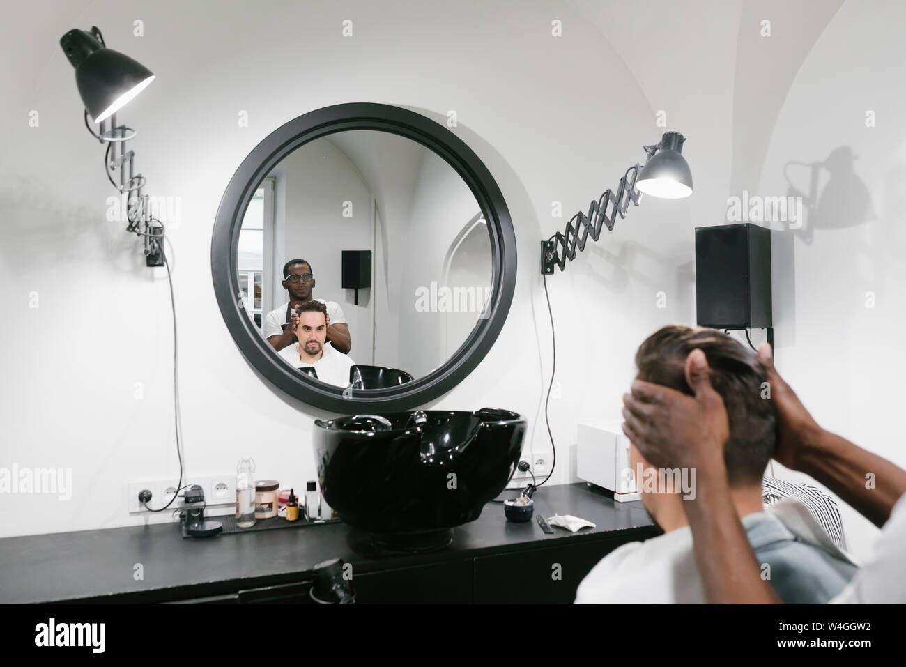 Man doing hair in mirror hi-res stock photography and images - Alamy