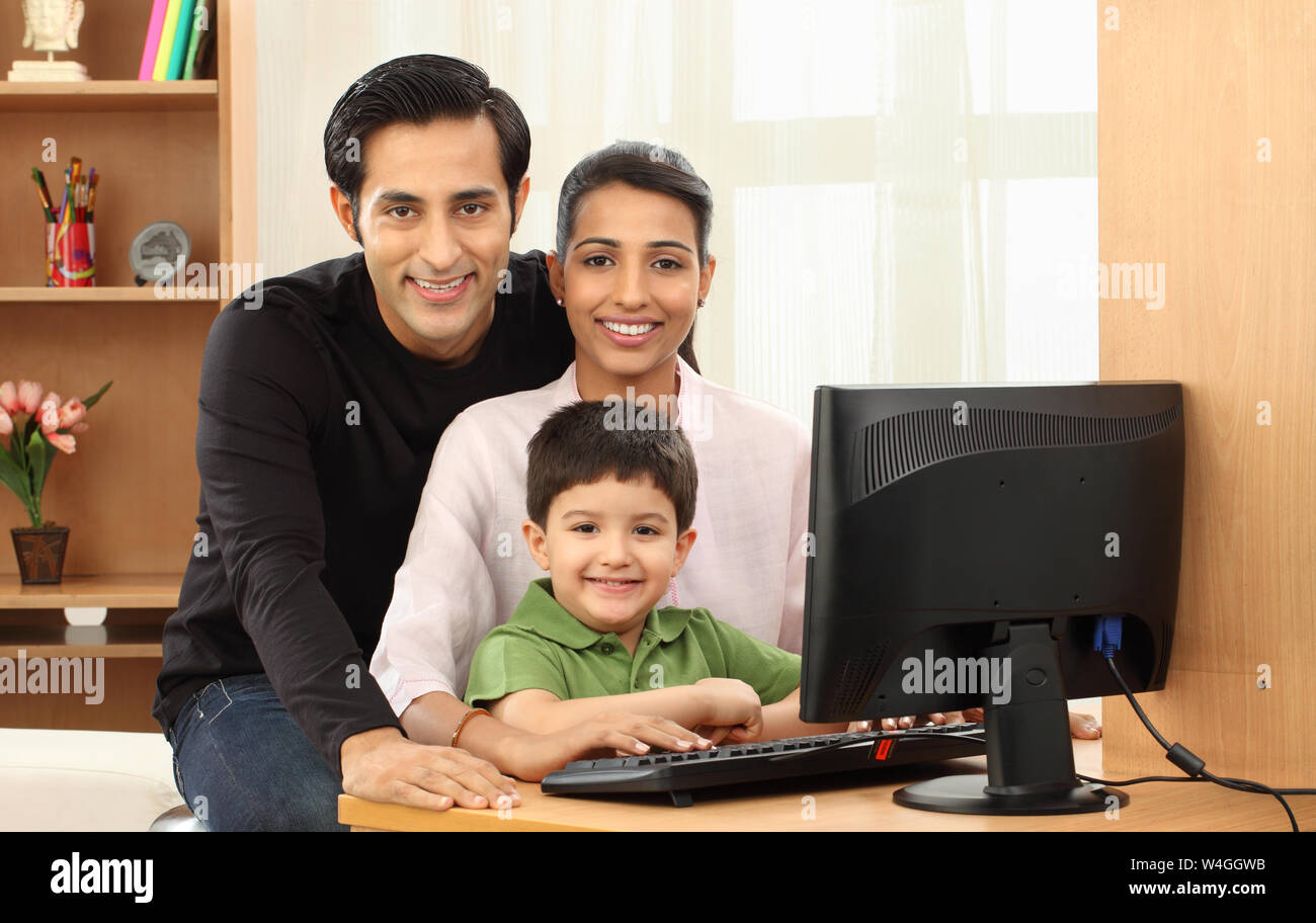 Family working on a computer Stock Photo - Alamy