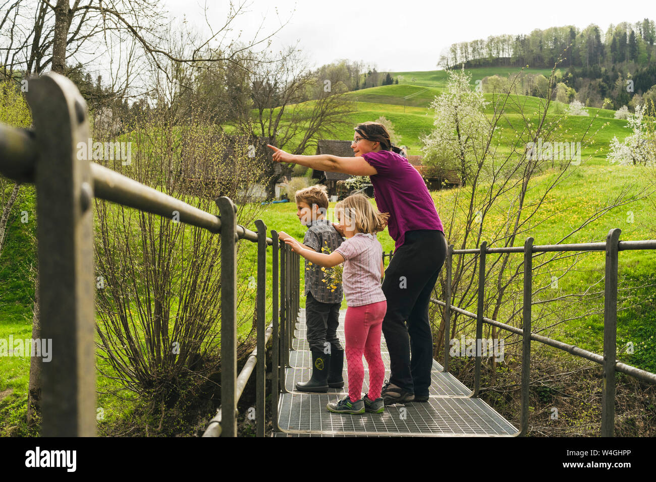 Mother with two children on a bridge in the countryside Stock Photo - Alamy