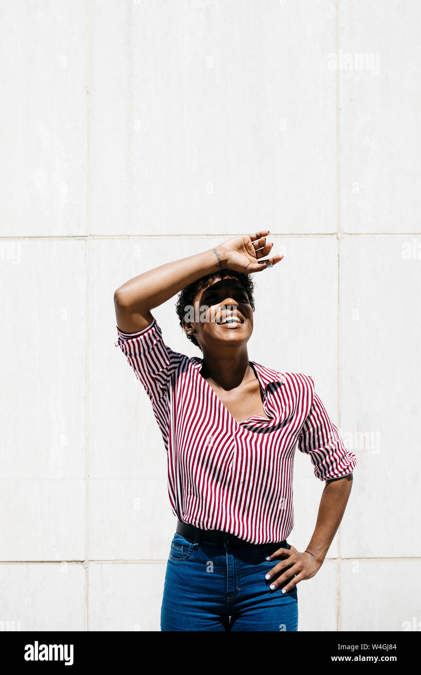 Portrait of woman covering the sun with her arm hi-res stock ...