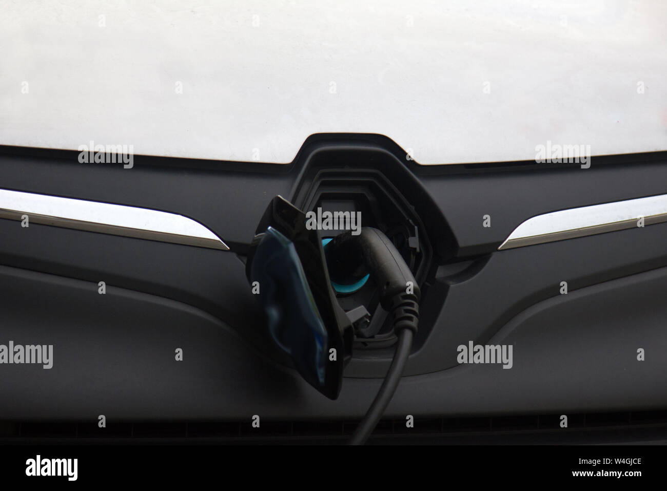 The charging socket of the electric vehicle. The plug in the socket ...