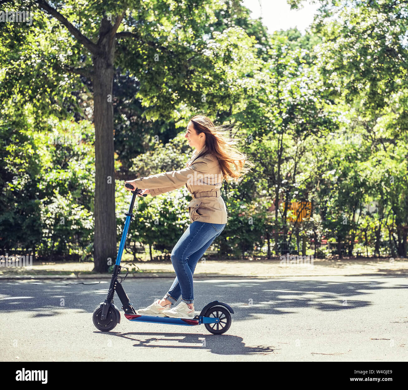 Woman riding e scooter hi-res stock photography and images - Alamy