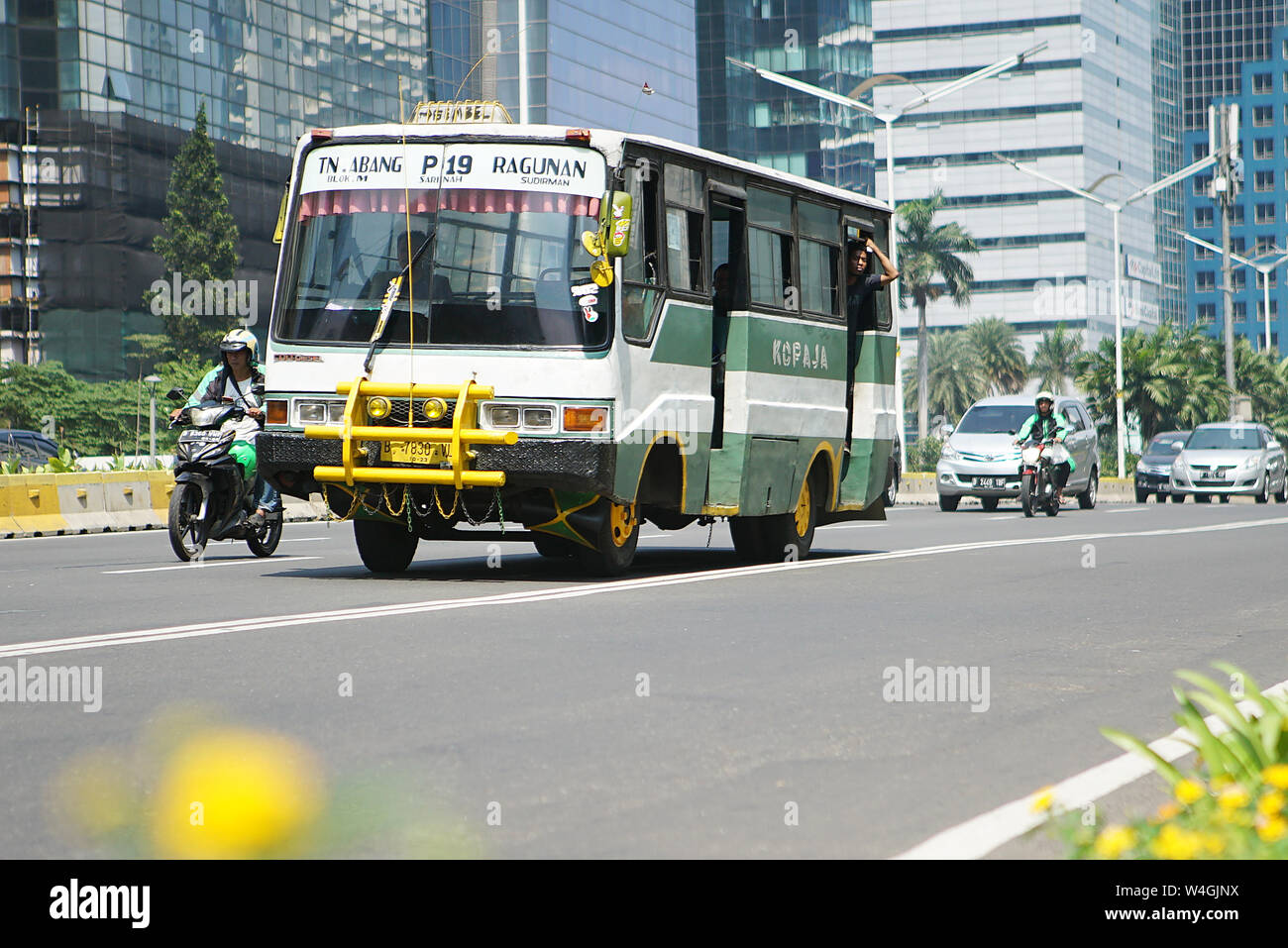 Kopaja, old system transportation bus in Jakarta, passing at Sudirman ...