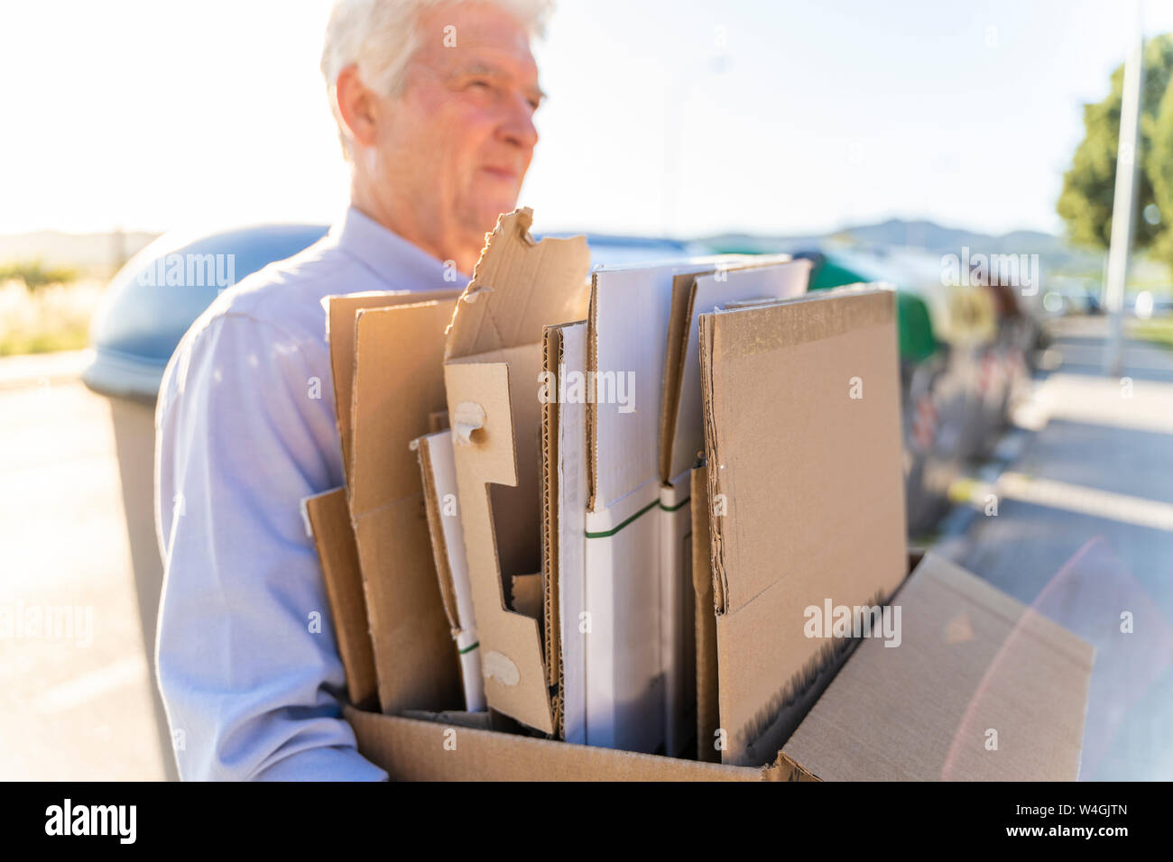 Senior man recycling cardboard carrying cardboard box Stock Photo - Alamy