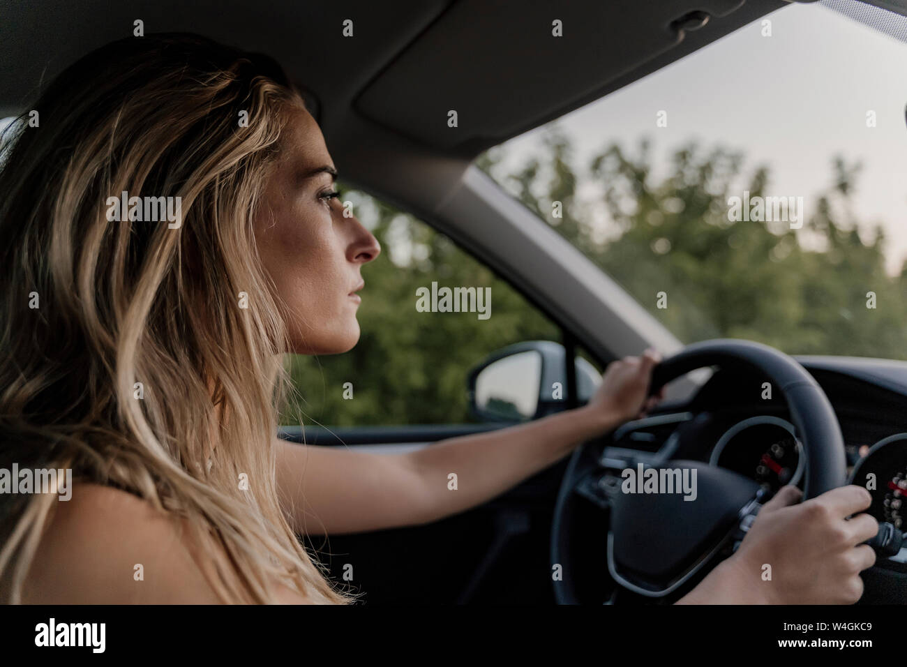 Blond woman driving car Stock Photo - Alamy